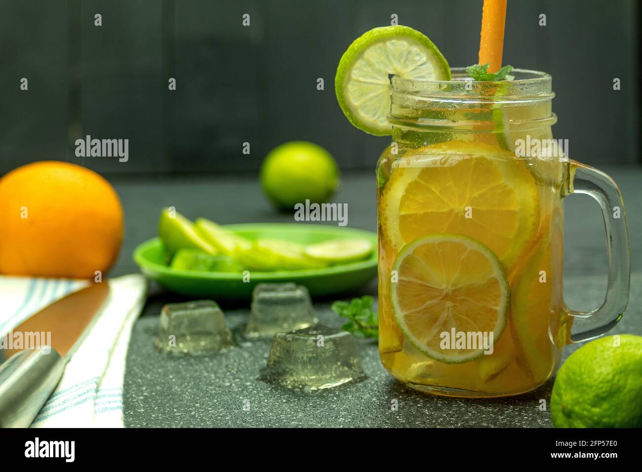 Cool lemonade made from orange and ice cubes. Water drops. Refreshing ...