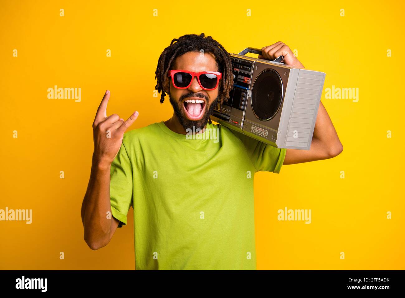 Photo of young man excited enjoy rock music show sign horn rocker hold ...
