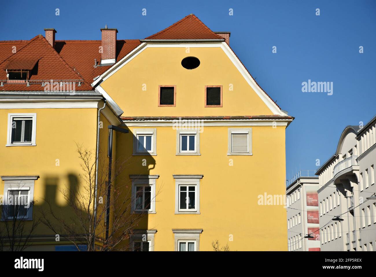 Neo-Classical building with stucco walls and red clay tile rooftops in ...