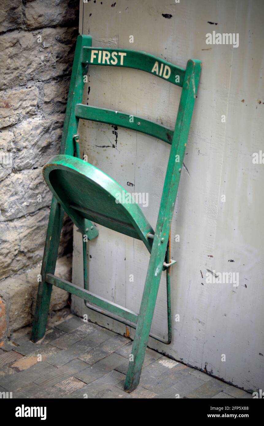 disgarded vintage green first aid folding chair Stock Photo - Alamy