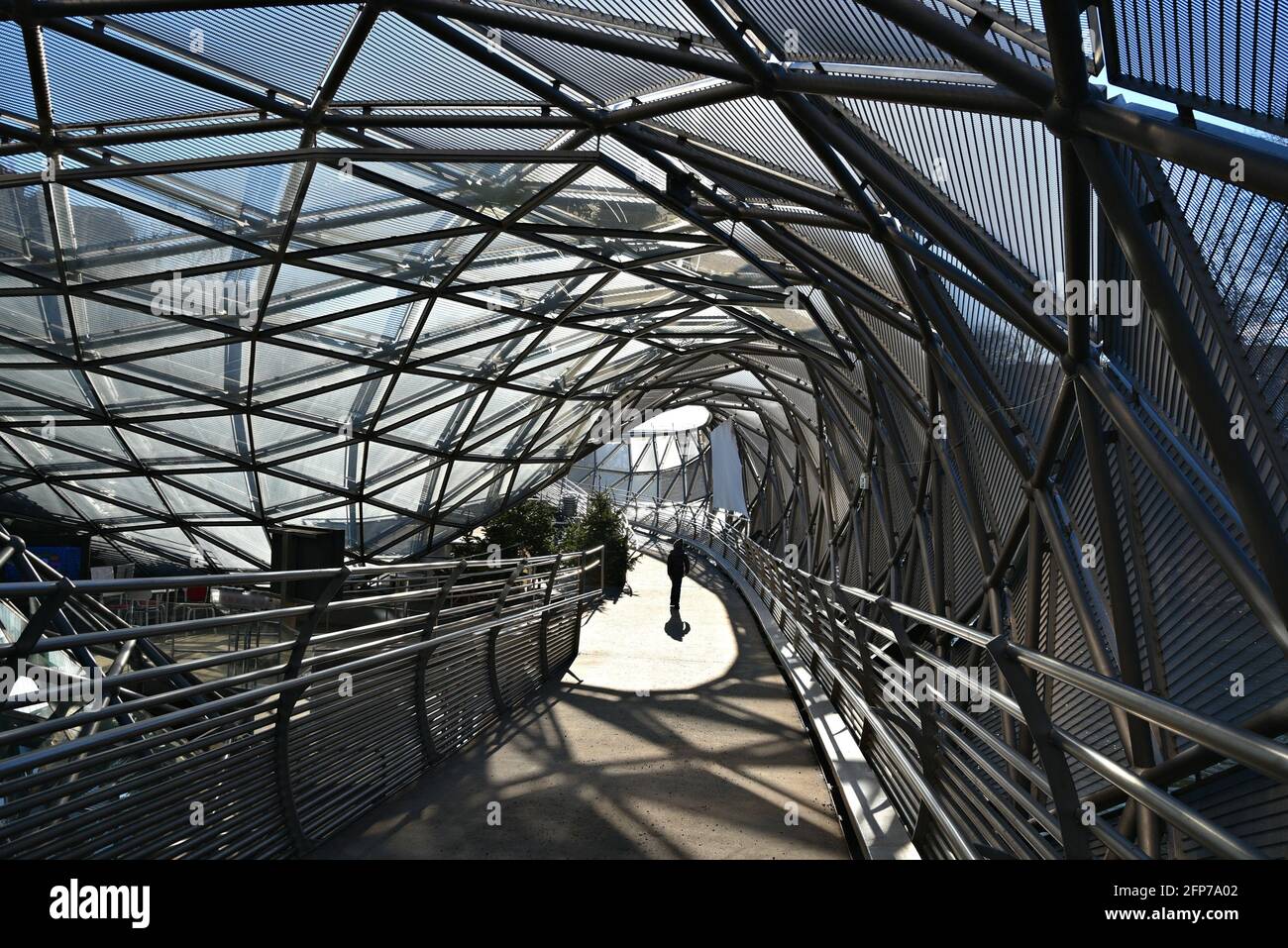 Silhouette walking on the steel footbridge of Murinsel, the peculiar ...