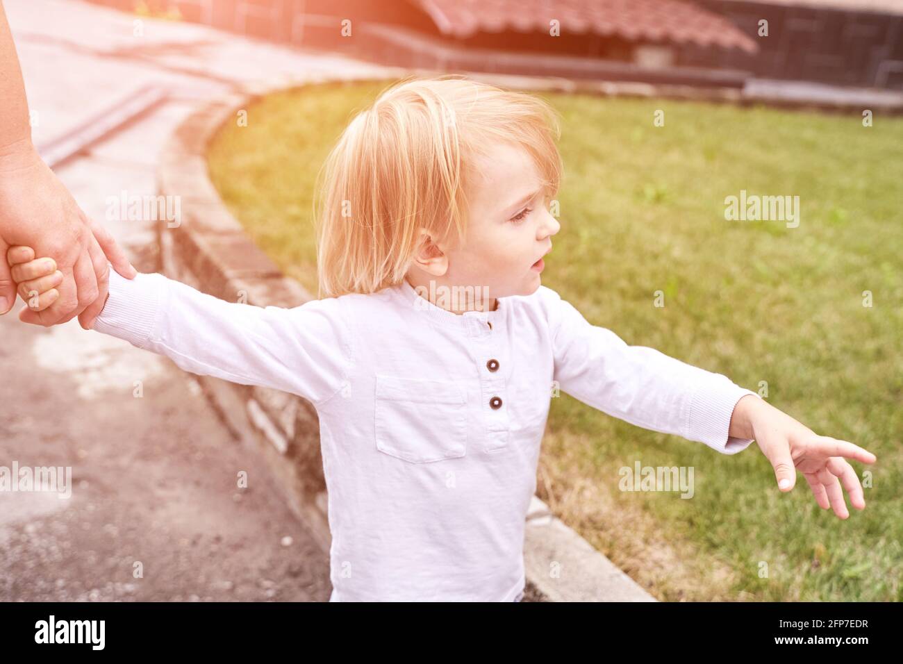 Mother hold sun hand. Outdoor family lifestyle Stock Photo - Alamy