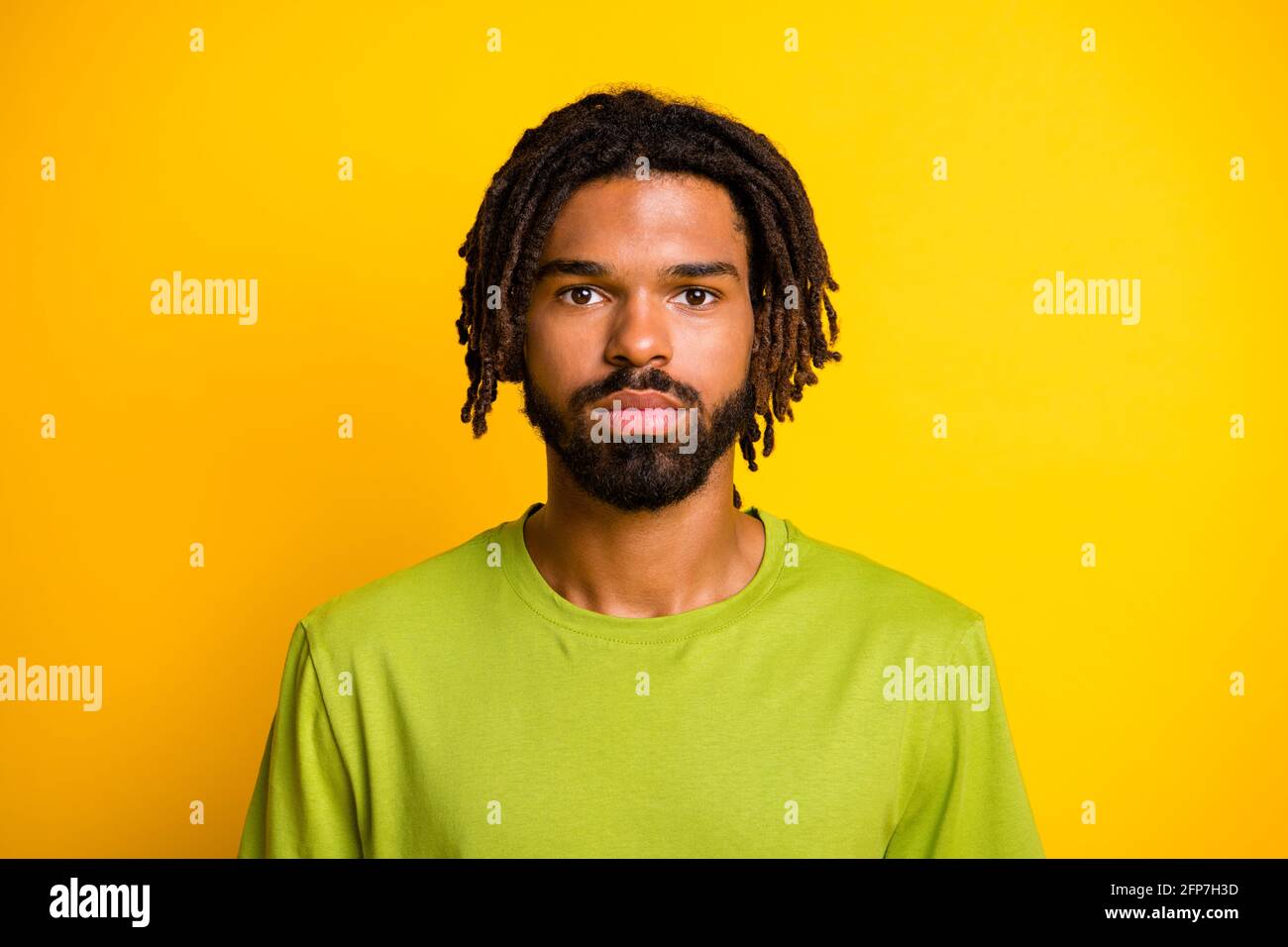 Portrait of serious dark skin guy look in camera isolated over vibrant ...