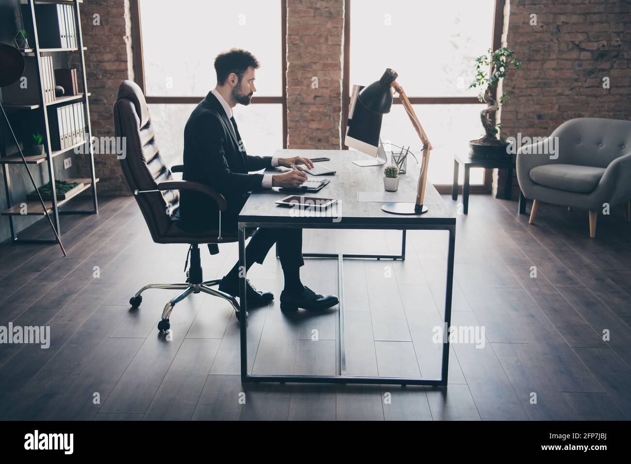 Photo of focused representative sit desk do busy work look computer ...