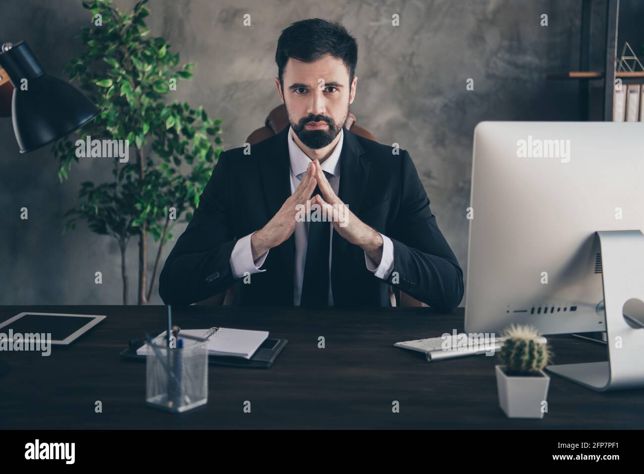 Photo of confident focused agent man sit desk hold fingers cool look ...