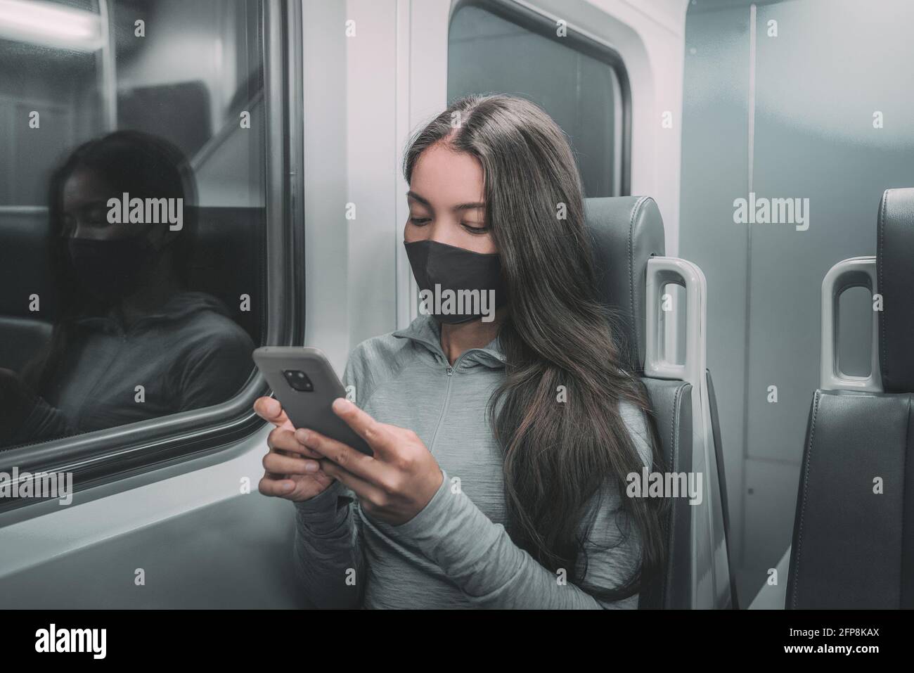 Public transport commute woman commuter at night wearing face mask ...