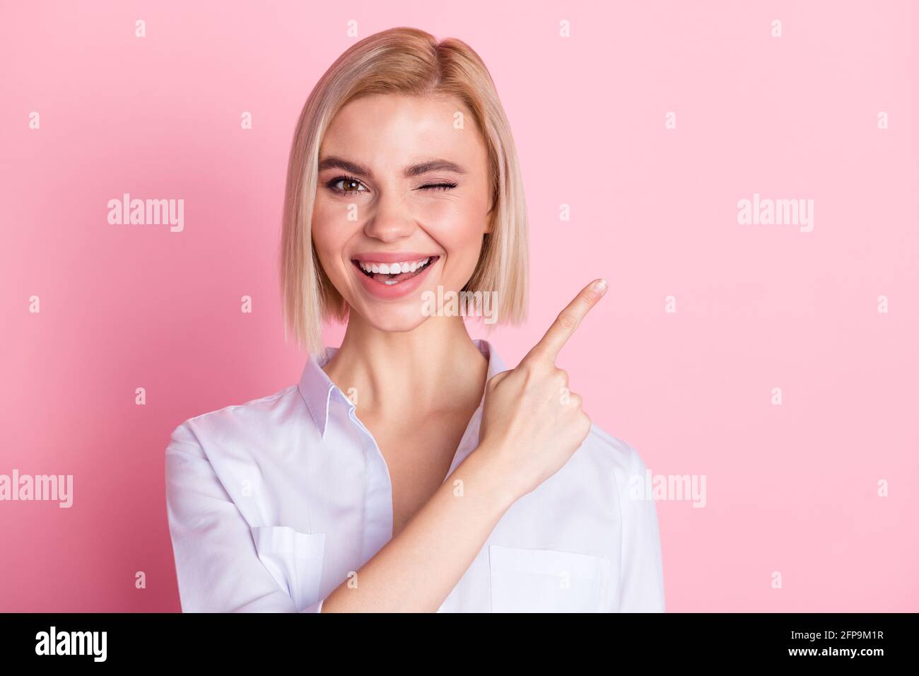 Photo of happy funky young charming lady wink eye point finger empty ...