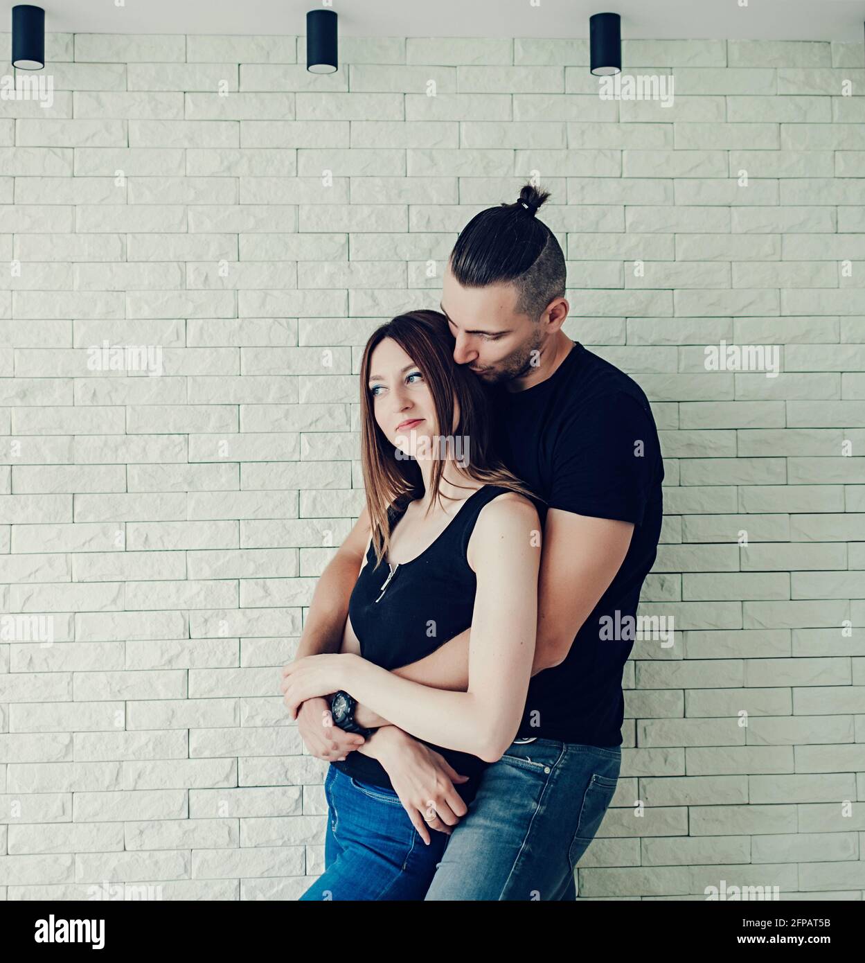 portrait romantic couple on bricks background love concept Stock Photo ...
