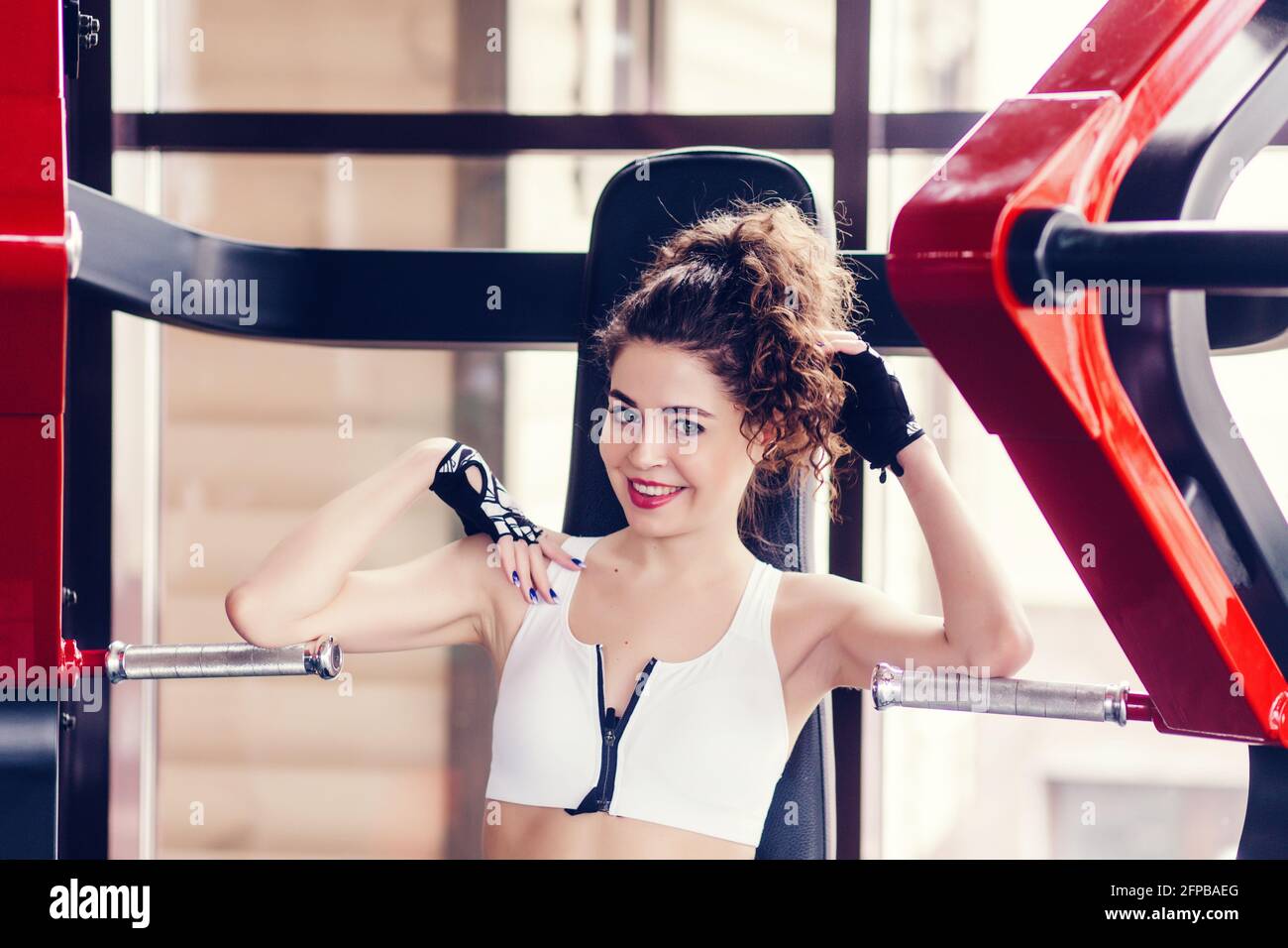 portrait of fit young woman resting after workout in gym Stock Photo ...