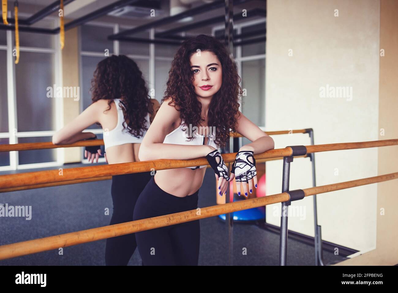 Young woman relaxing gym after her workout. Female athlete taking rest ...