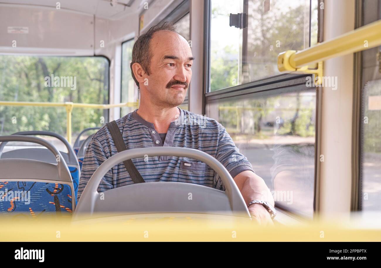 Portrait of senior Asian man in public transport Stock Photo - Alamy