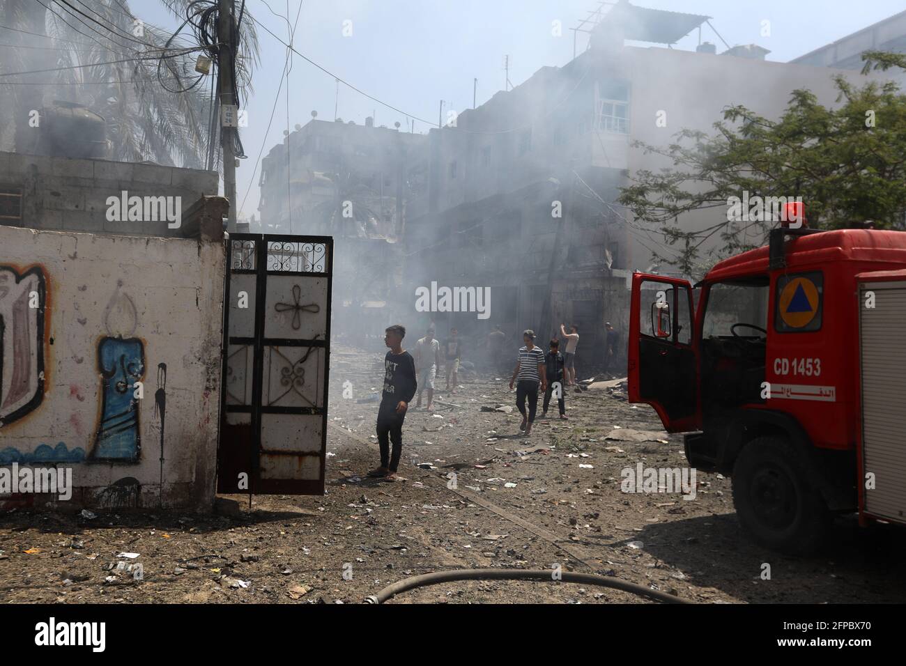 Smoke rises from a 14-story building as Israeli fighter jets continue ...
