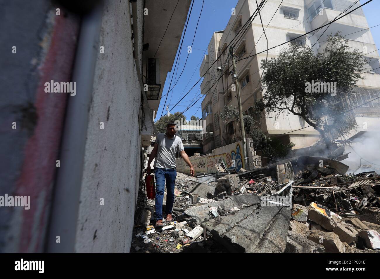 Smoke rises from a 14-story building as Israeli fighter jets continue ...