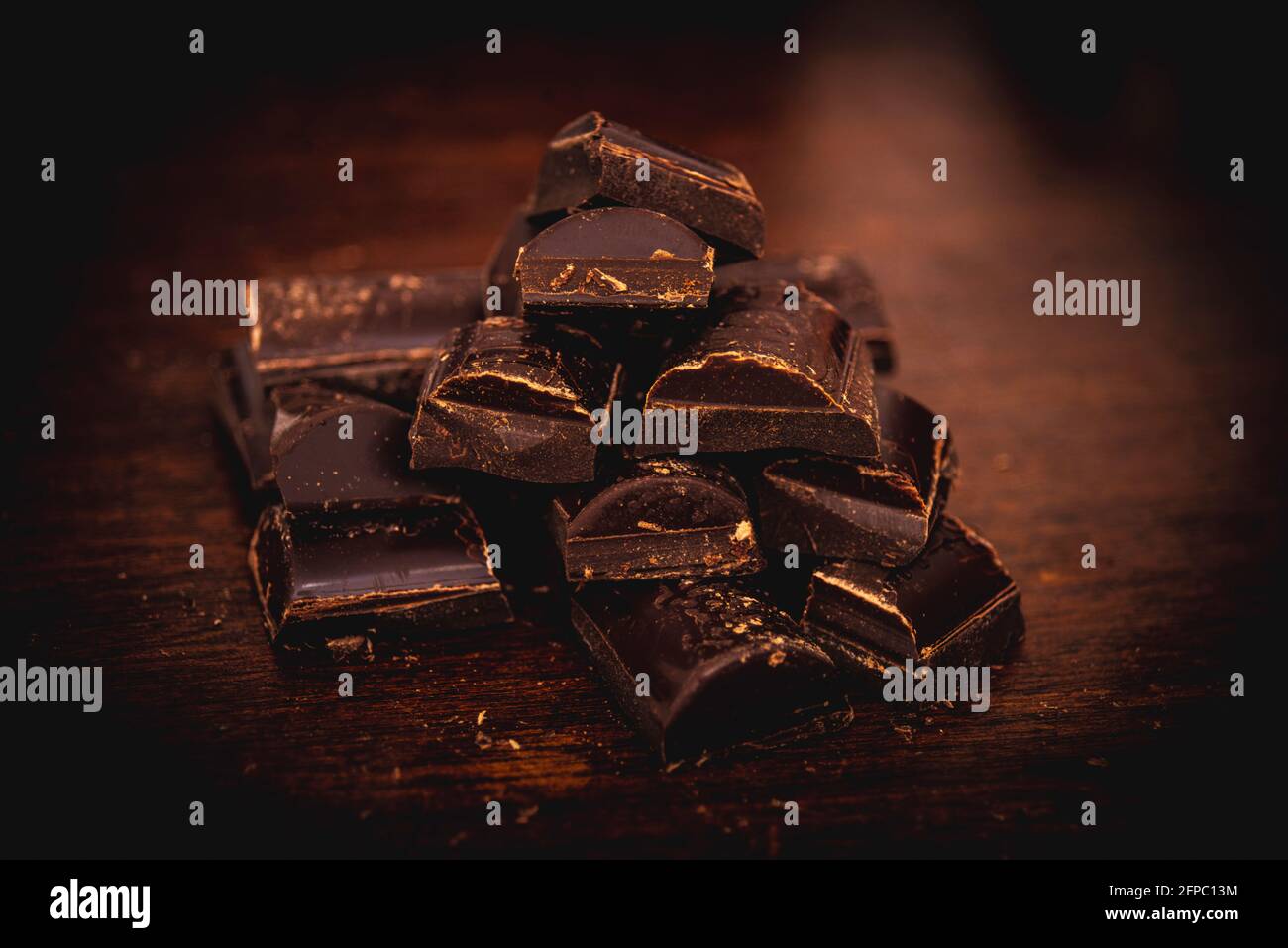 Bitter chocolate with peanuts in bar on dark background with ...