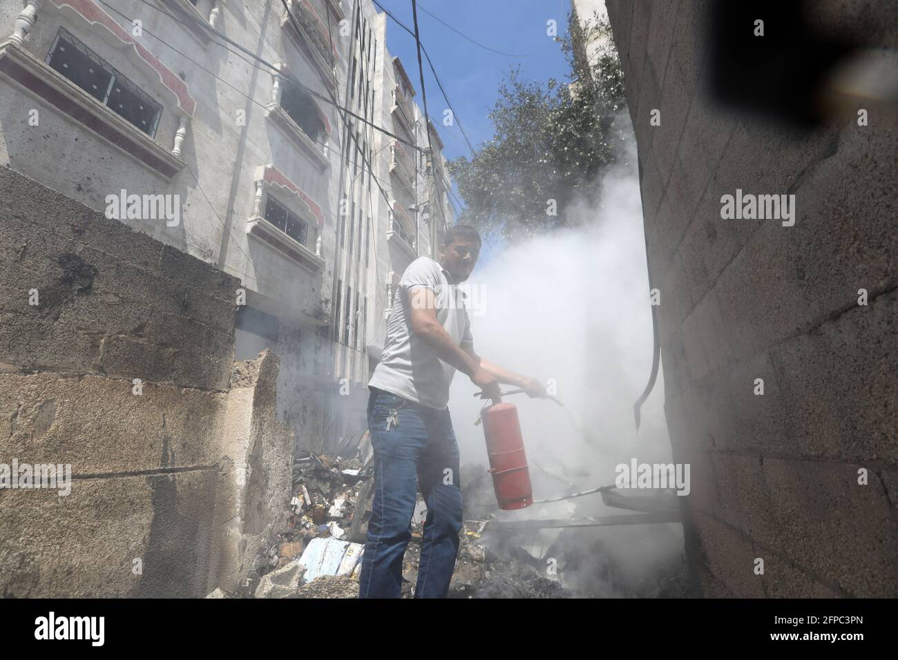 Smoke rises from a 14-story building as Israeli fighter jets continue ...