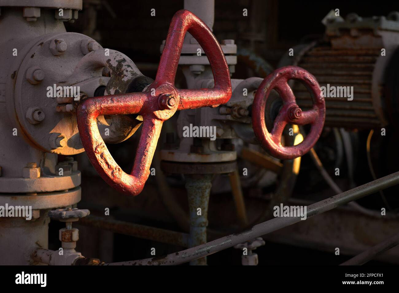 Two retro design industrial butterfly valves with red handwheels over ...