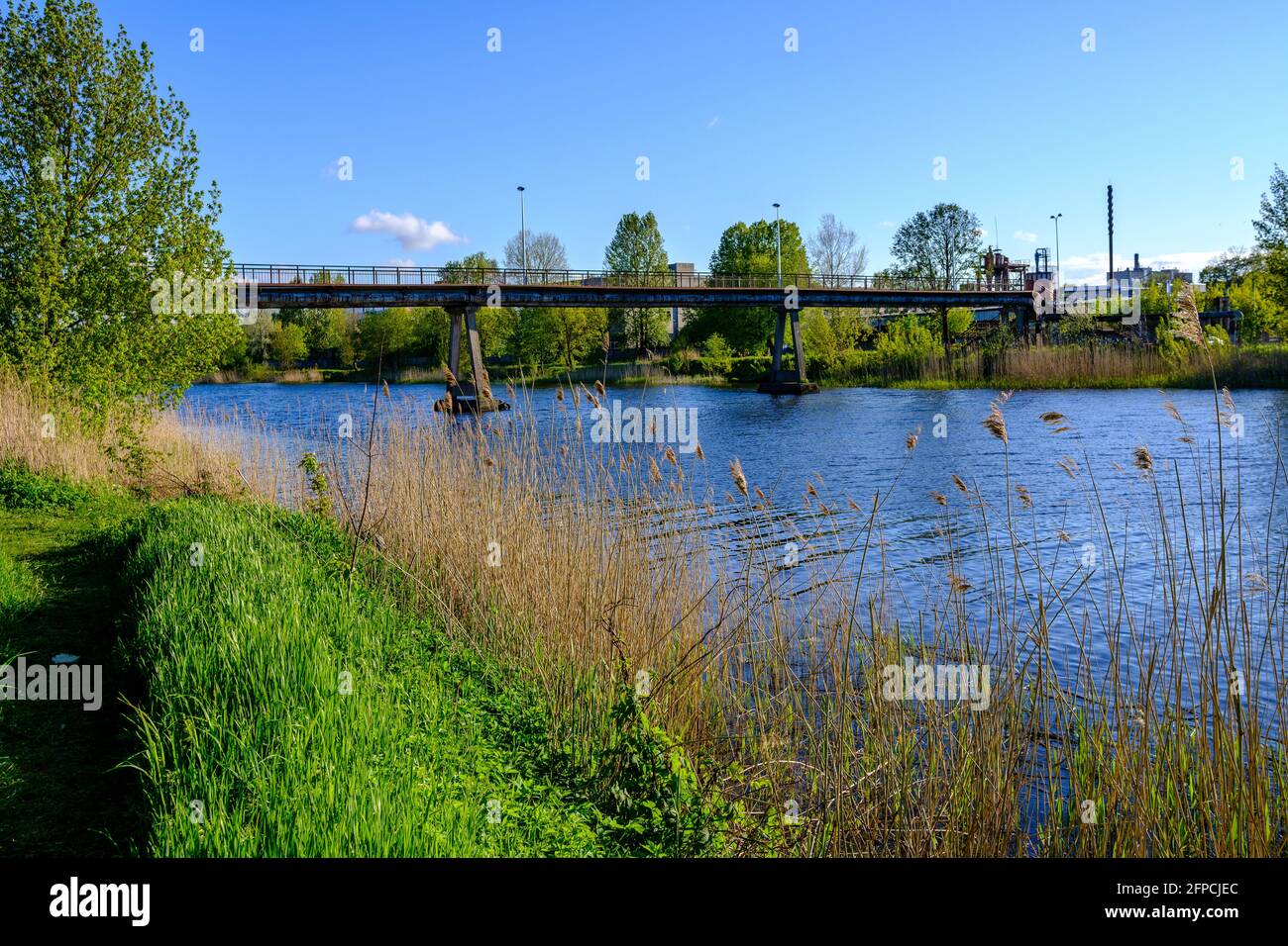 wide river landscape scene with large body of water, blue reflections ...