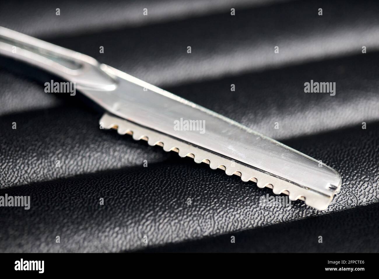 Barbershop tool. Selective focus, part of barber thinning razor layer ...