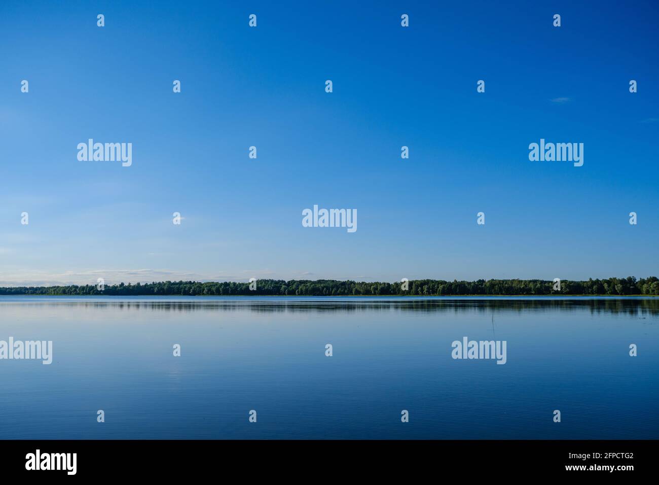 wide river landscape scene with large body of water, blue reflections ...