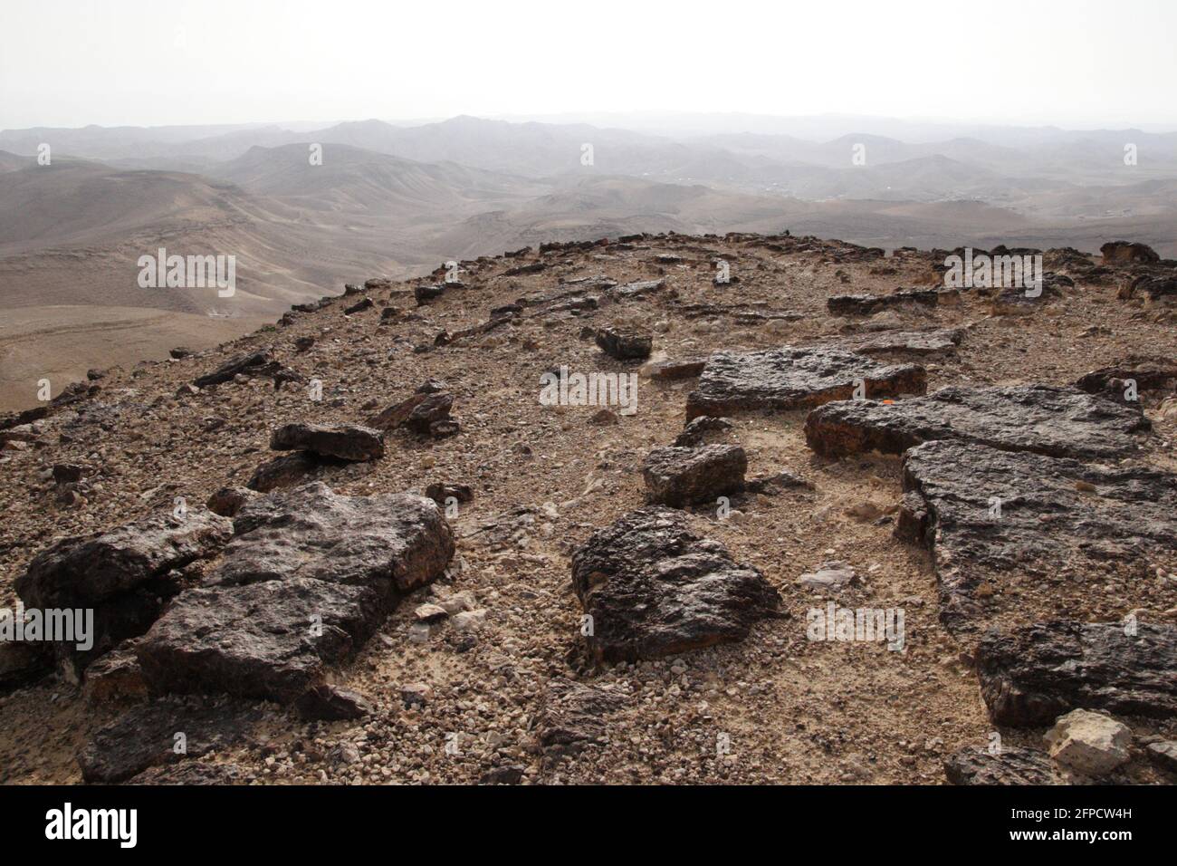 Flintstone rocks on a hill near the city of Arad overlooking the arid ...