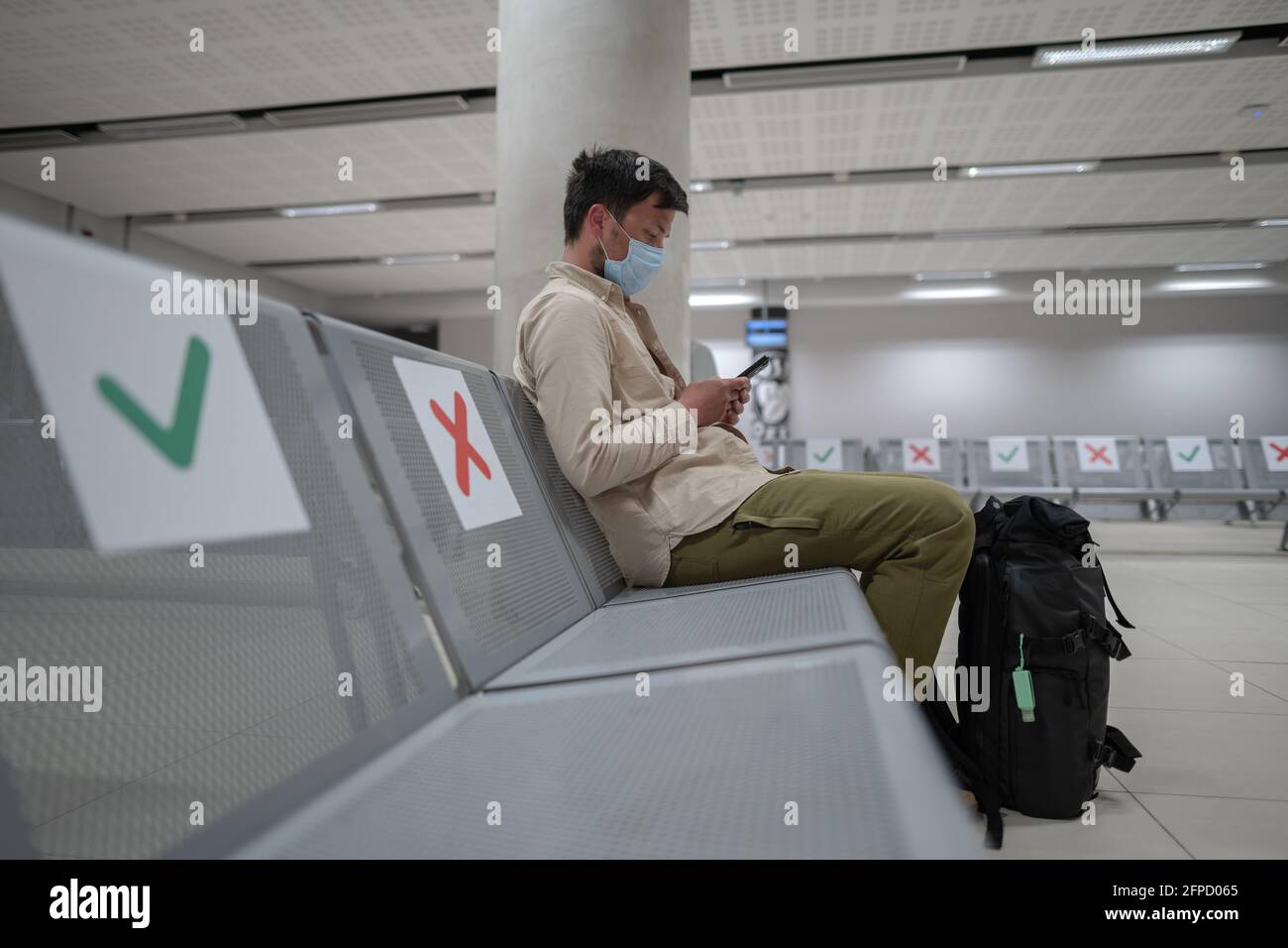 Traveler sits at international airport of Cyprus, Paphos during COVID ...