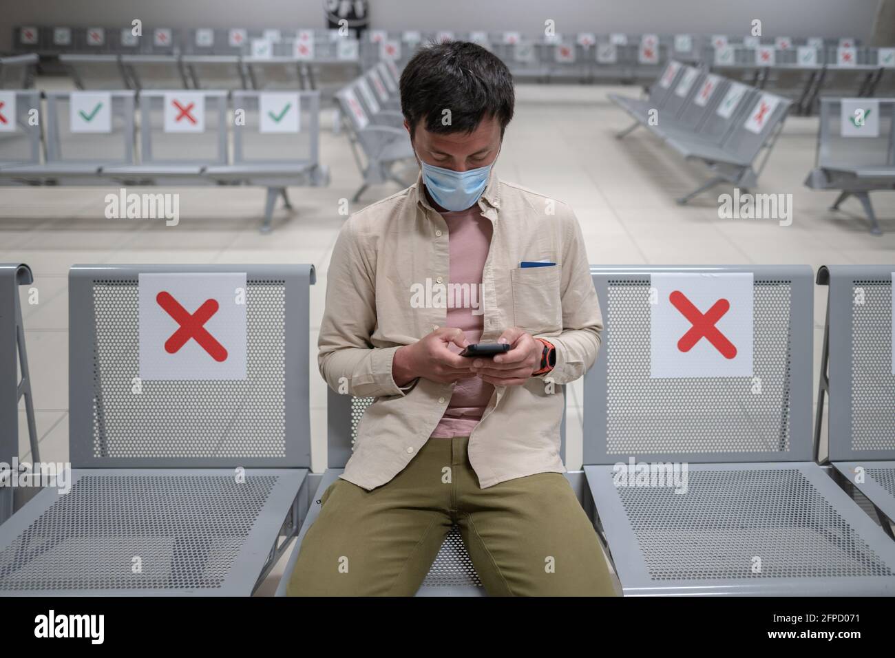 Traveler sits at international airport of Cyprus, Paphos during COVID ...
