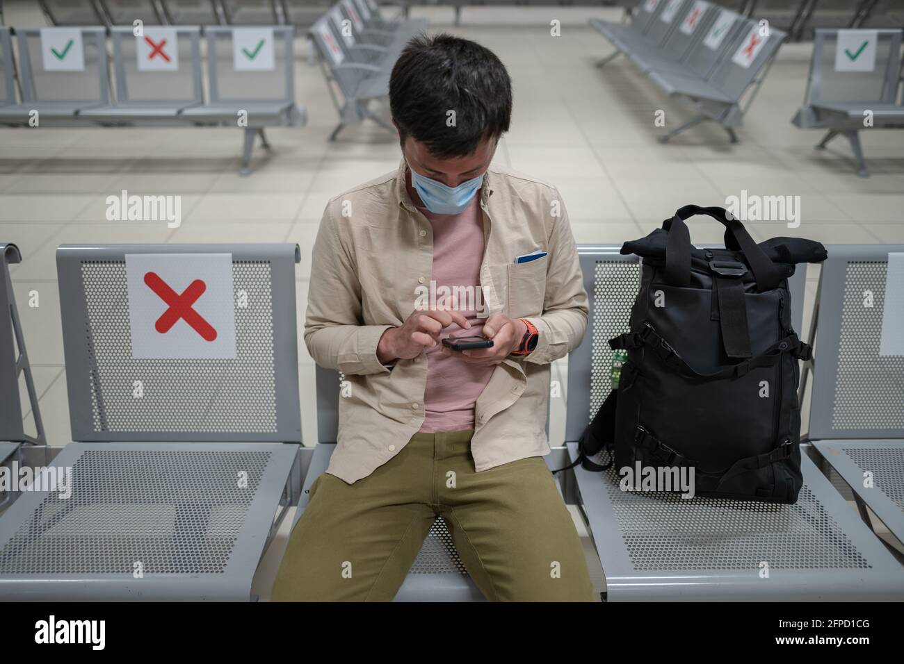 Traveler sits at international airport of Cyprus, Paphos during COVID ...
