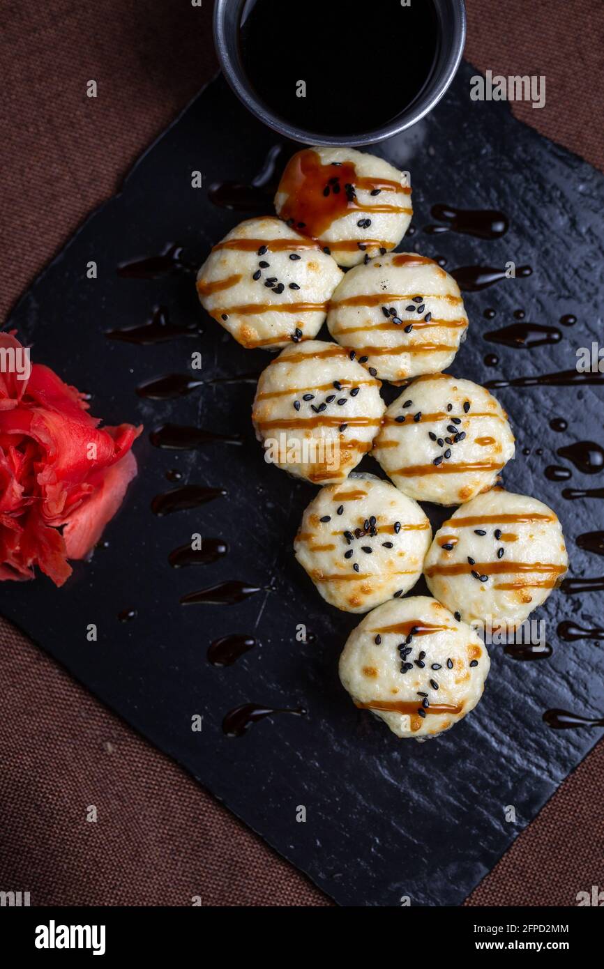 baked rolls with eel and cheese and sauce Stock Photo - Alamy