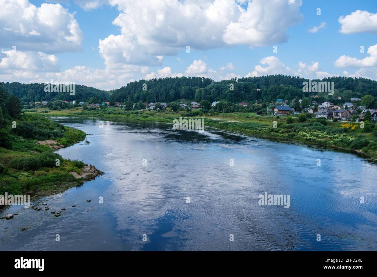 wide river landscape scene with large body of water, blue reflections ...