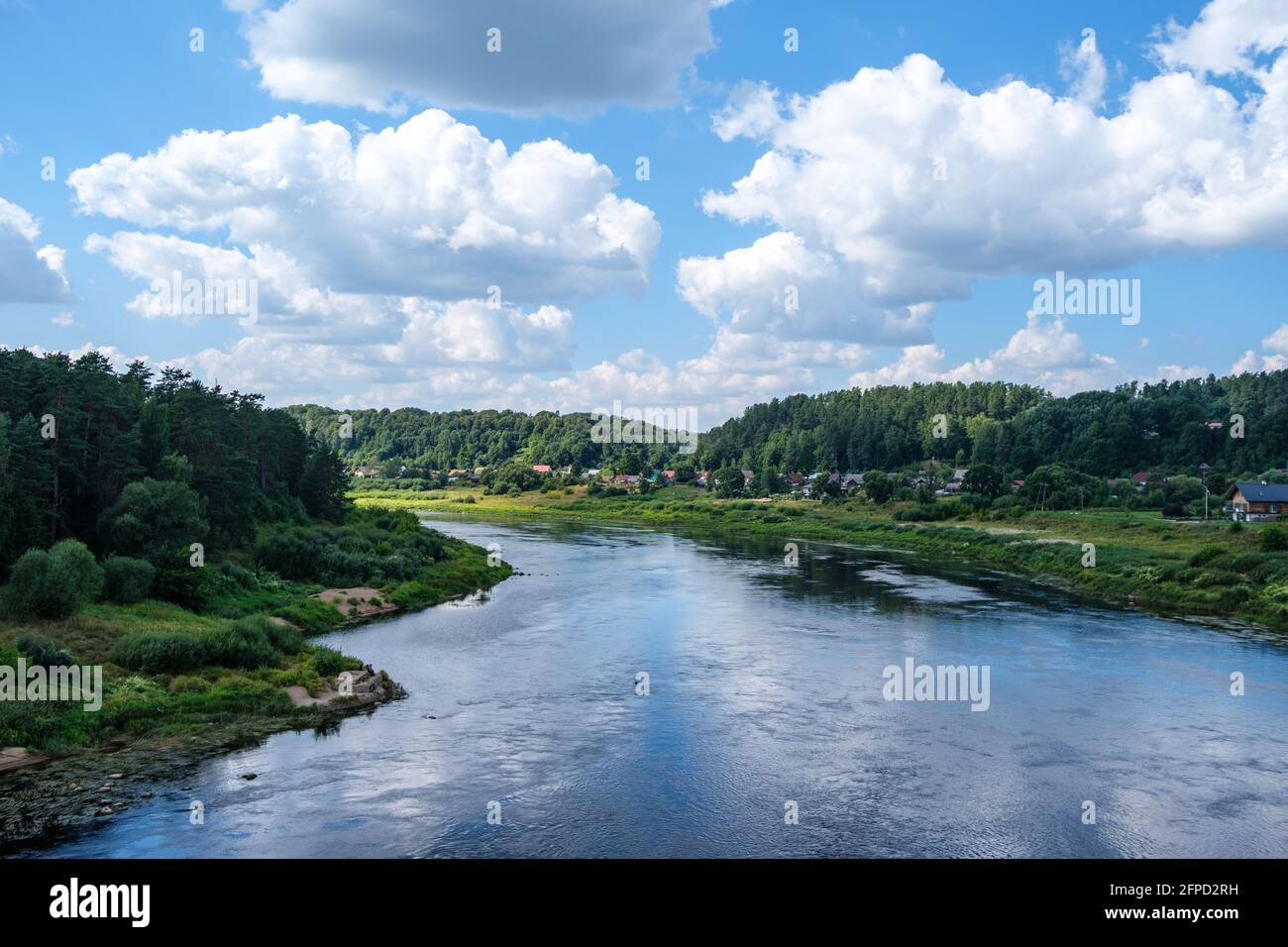 wide river landscape scene with large body of water, blue reflections ...