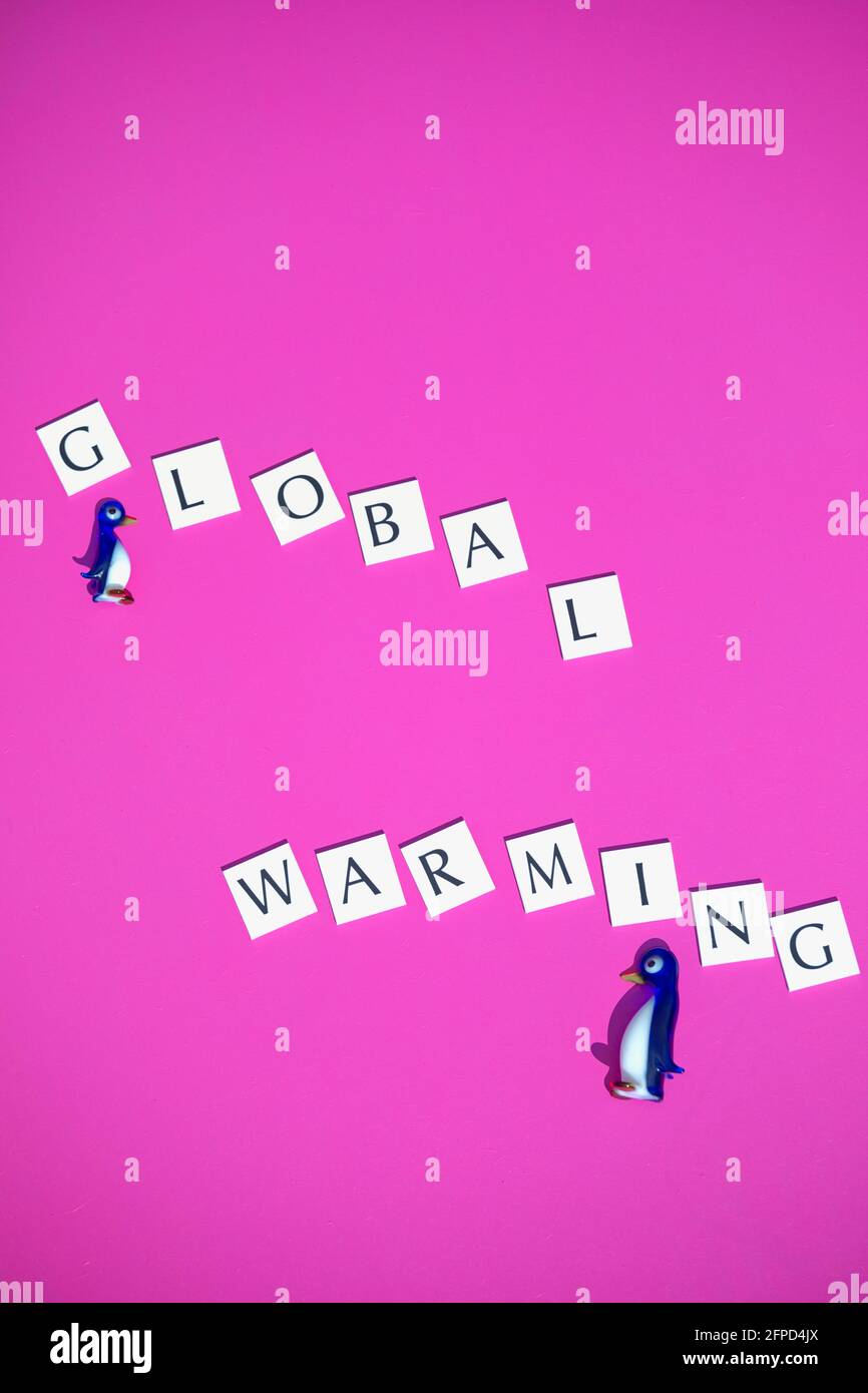 Directly above of two glass penguins and the words global warming on ...