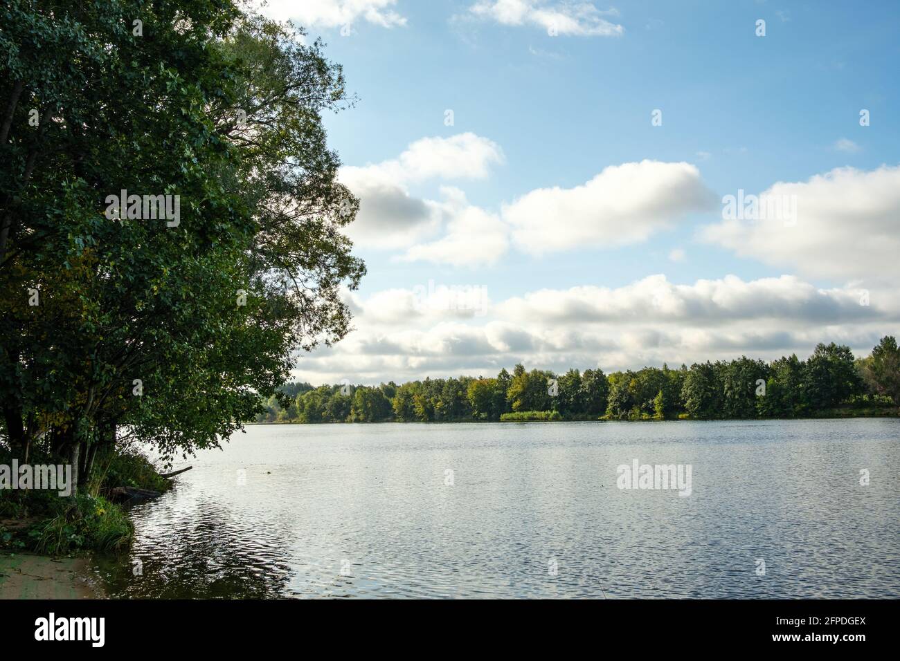 wide river landscape scene with large body of water, blue reflections ...