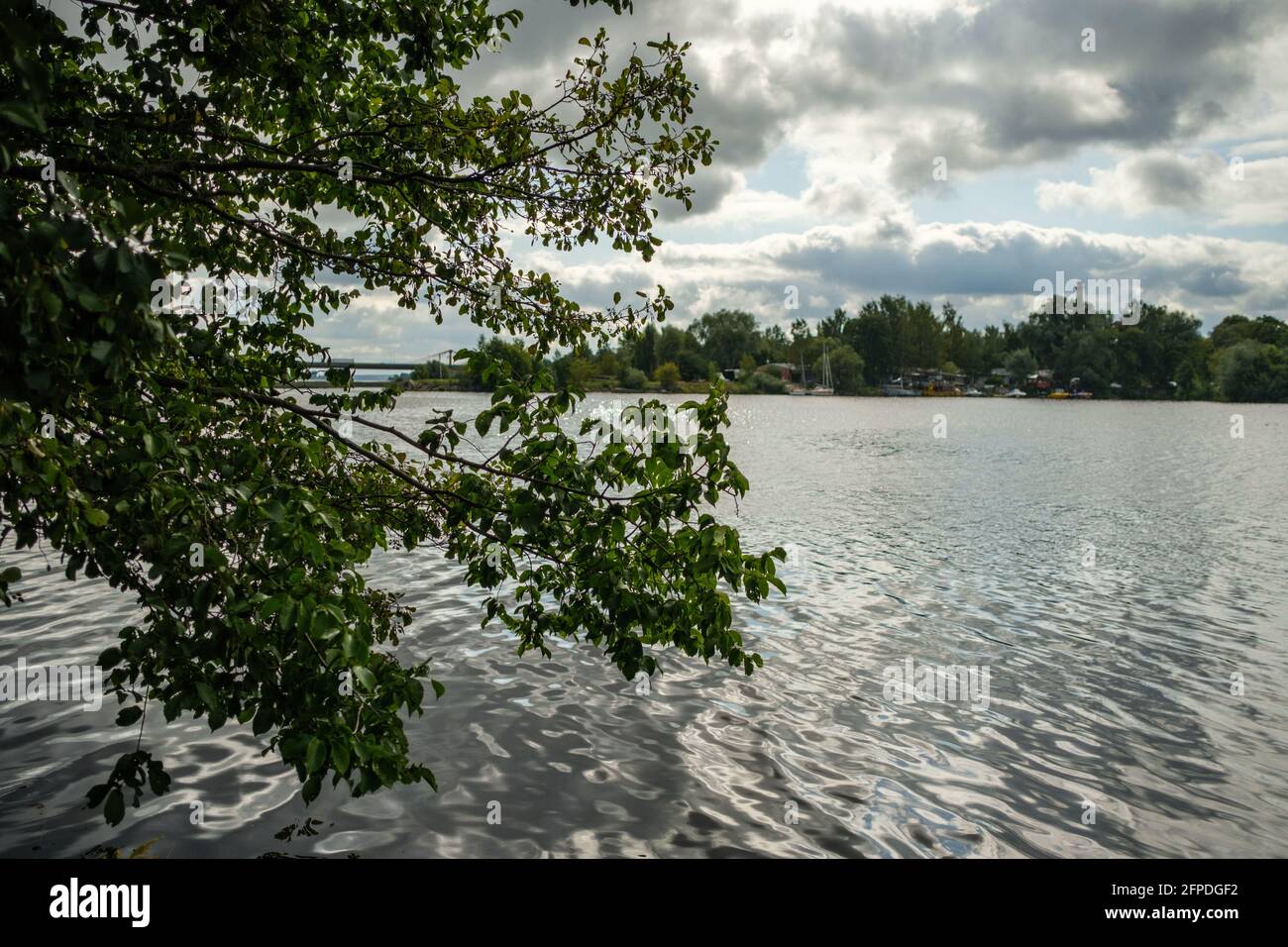 wide river landscape scene with large body of water, blue reflections ...