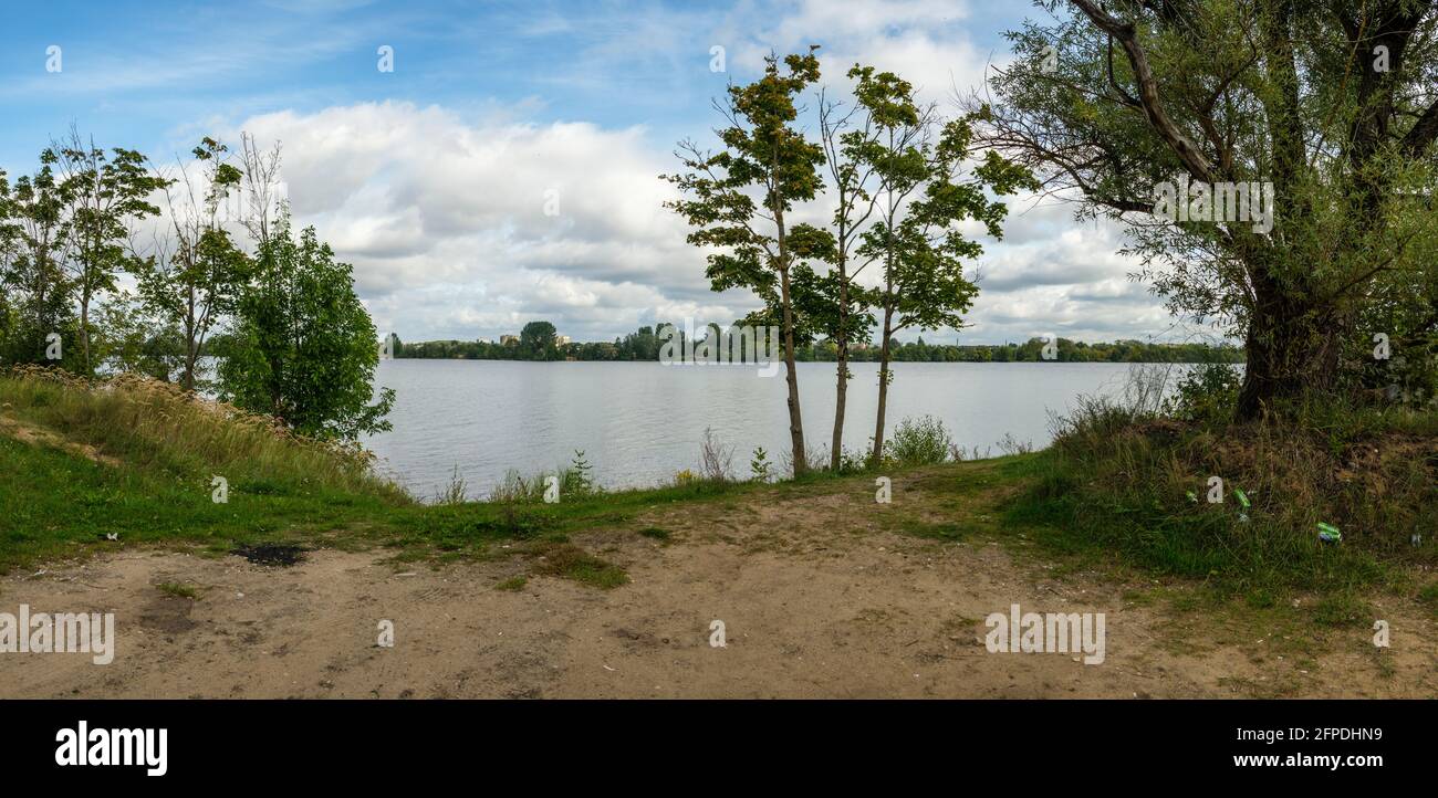 wide river landscape scene with large body of water, blue reflections ...