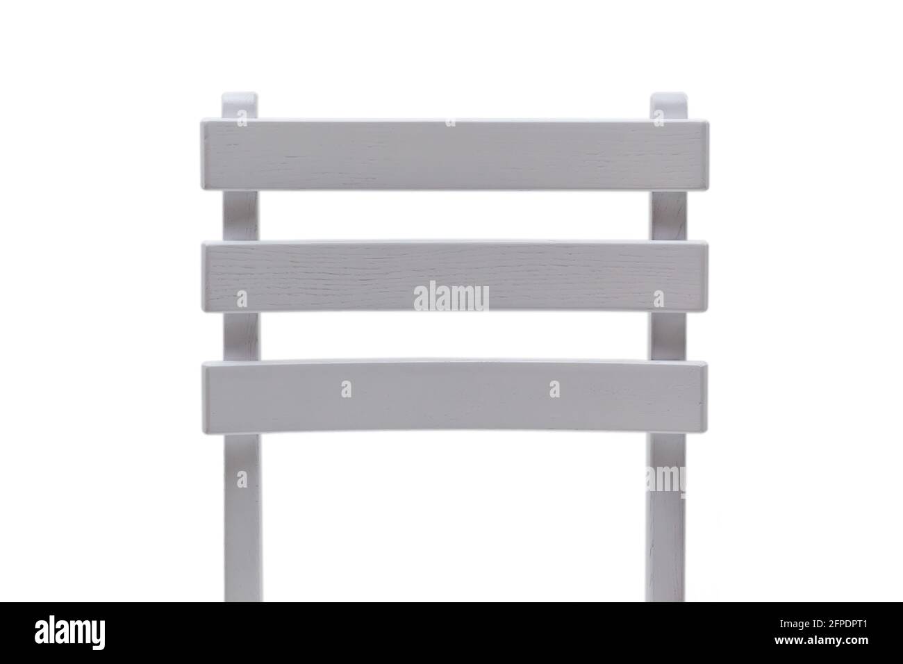 The back of a wooden chair with a texture, painted white, view from the ...