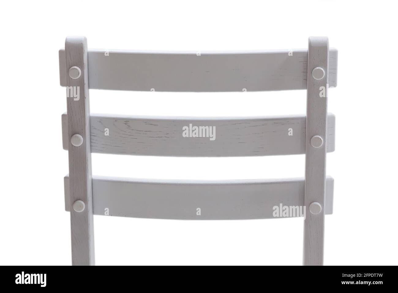 The back of a wooden chair with a texture, painted white, view from the ...