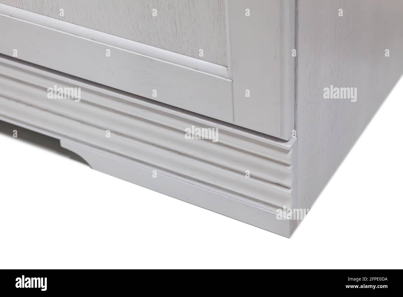 Bottom corner of a white modern kitchen cabinet Stock Photo - Alamy