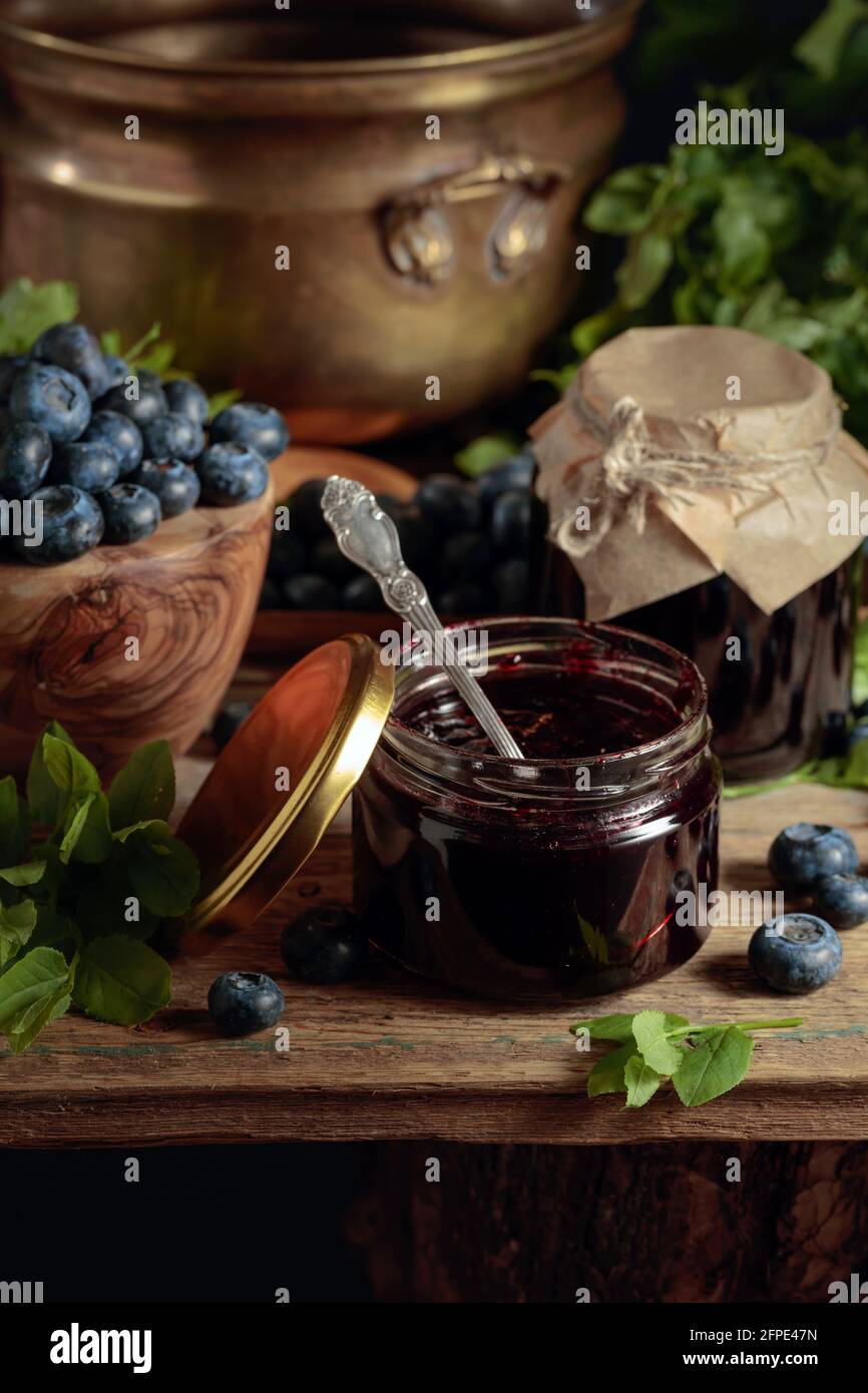 Blueberry jam with fresh berries on an old wooden table Stock Photo - Alamy