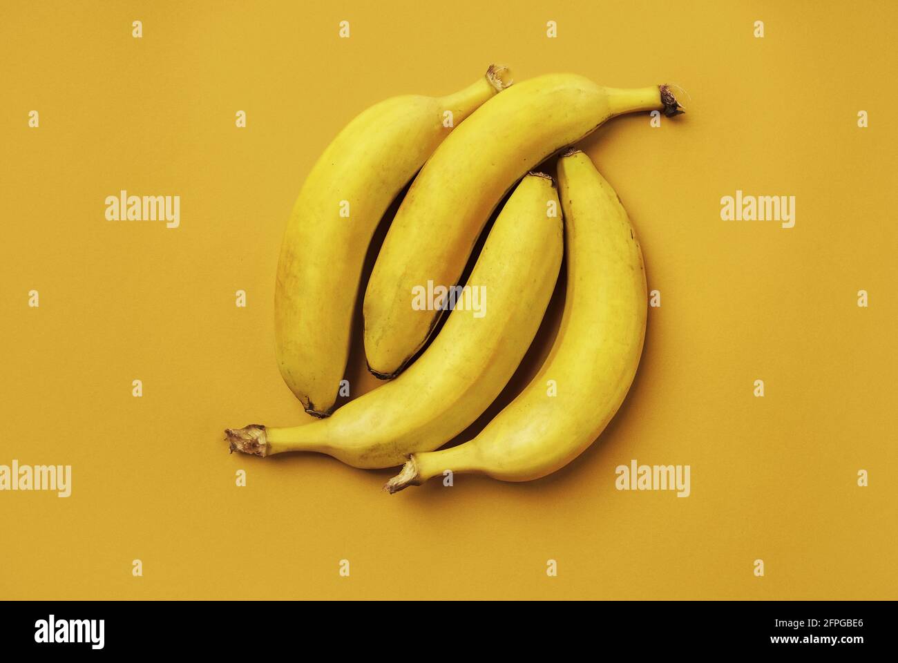 Top view of bananas isolated on the yellow background Stock Photo - Alamy