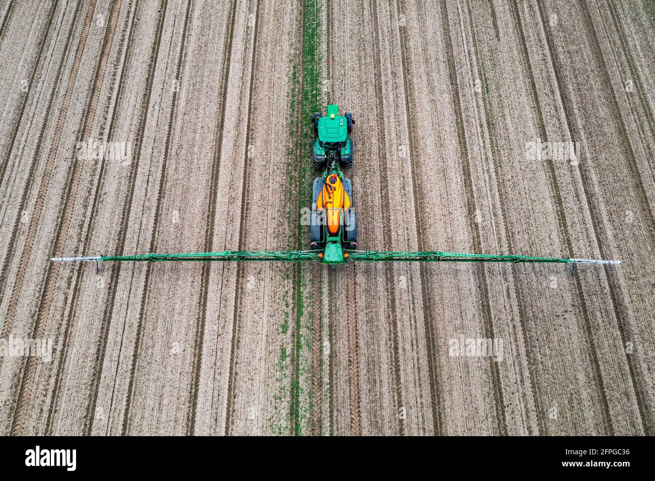 Farmer working a field, crop protection product is sprayed on, field ...