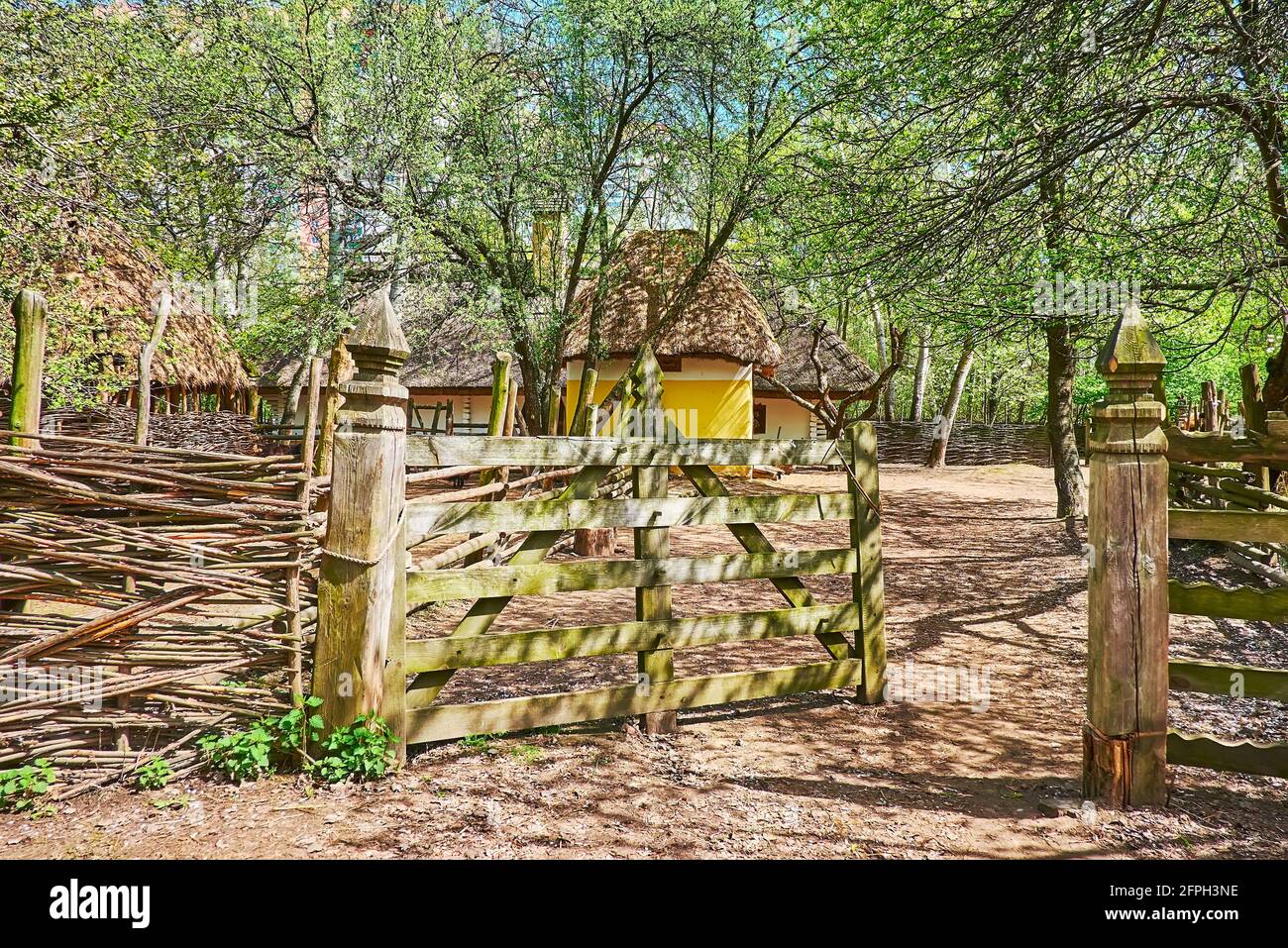 The medieval wooden gate and the wicker fence in front of the ...