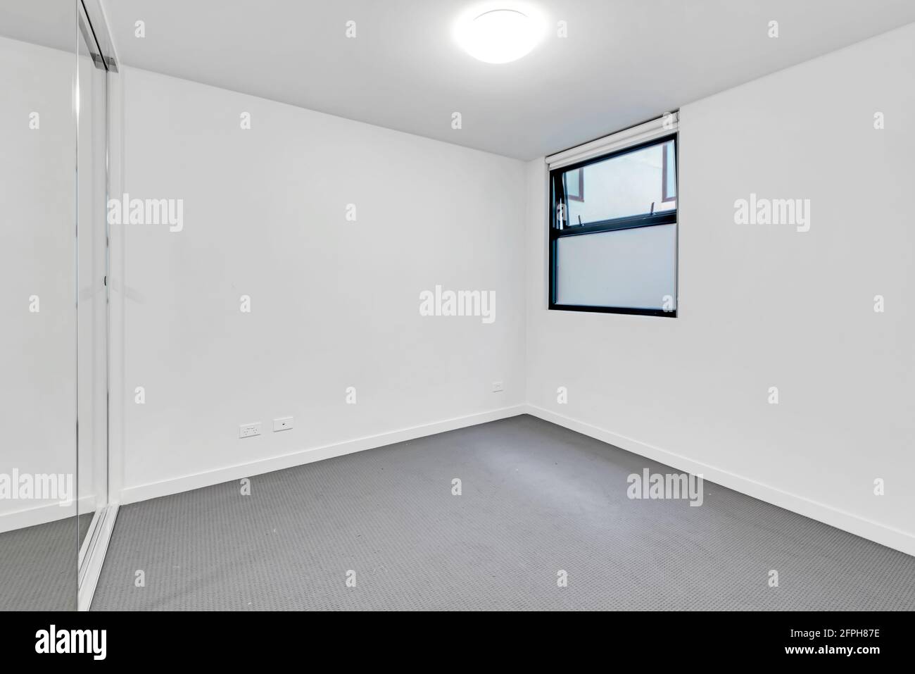 Unfurnished room divided into 2 parts with a glass door Stock Photo - Alamy