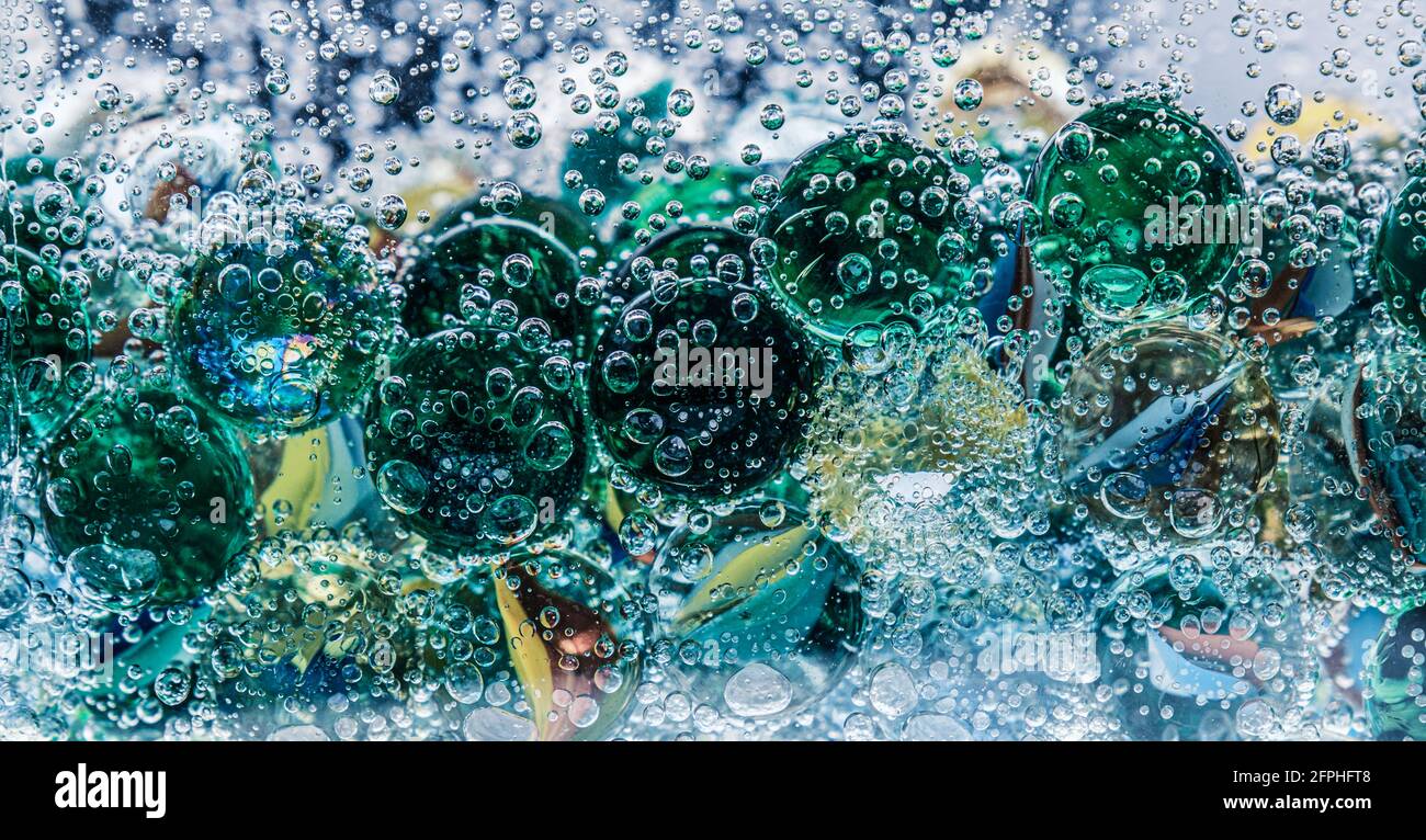 glass balls in mineral water with bubbles Stock Photo - Alamy