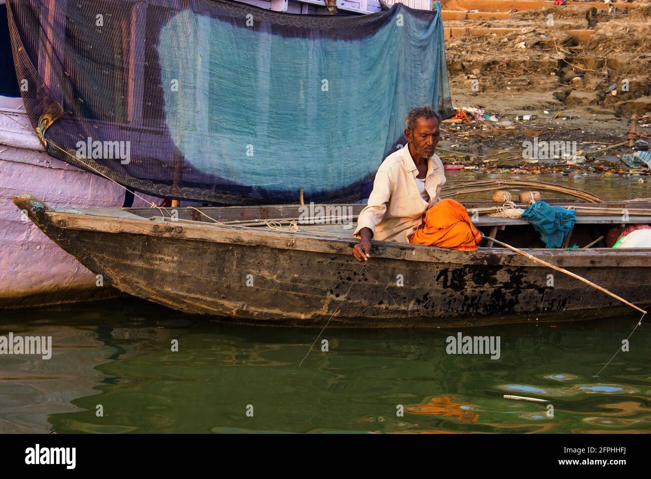 Indian man sitting on boat varanasi hi-res stock photography and images ...