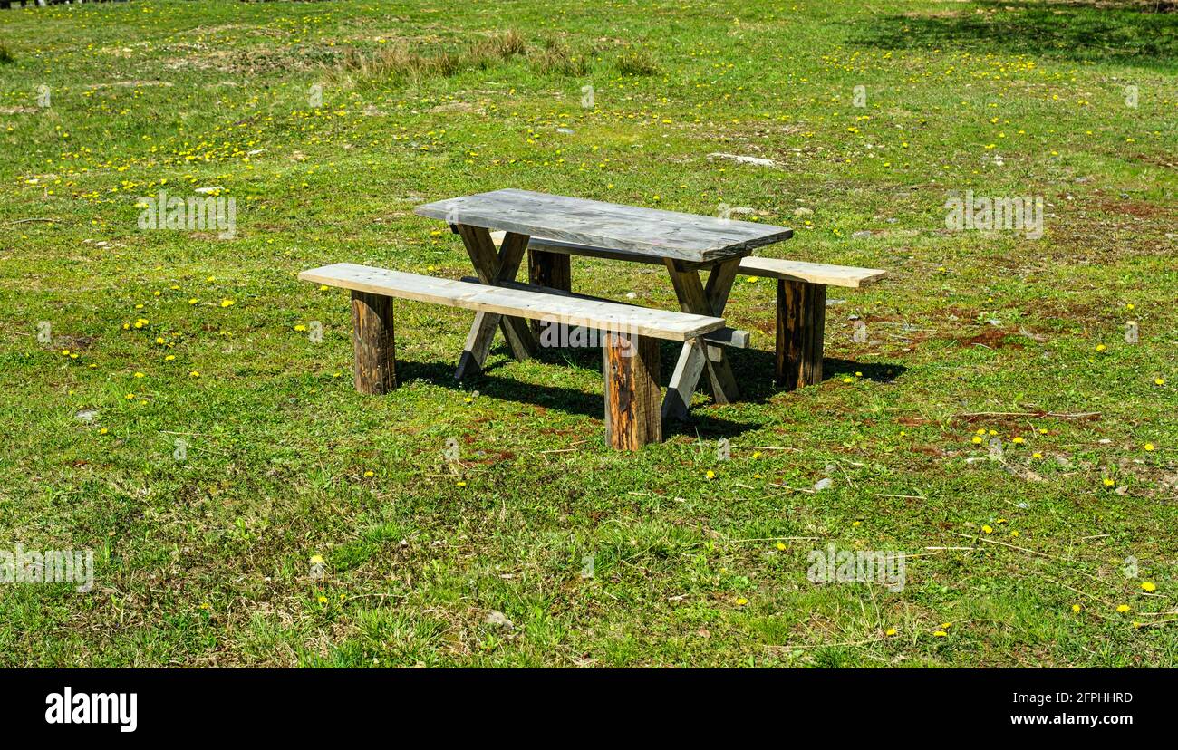 wooden table and bench in the flower field Stock Photo - Alamy