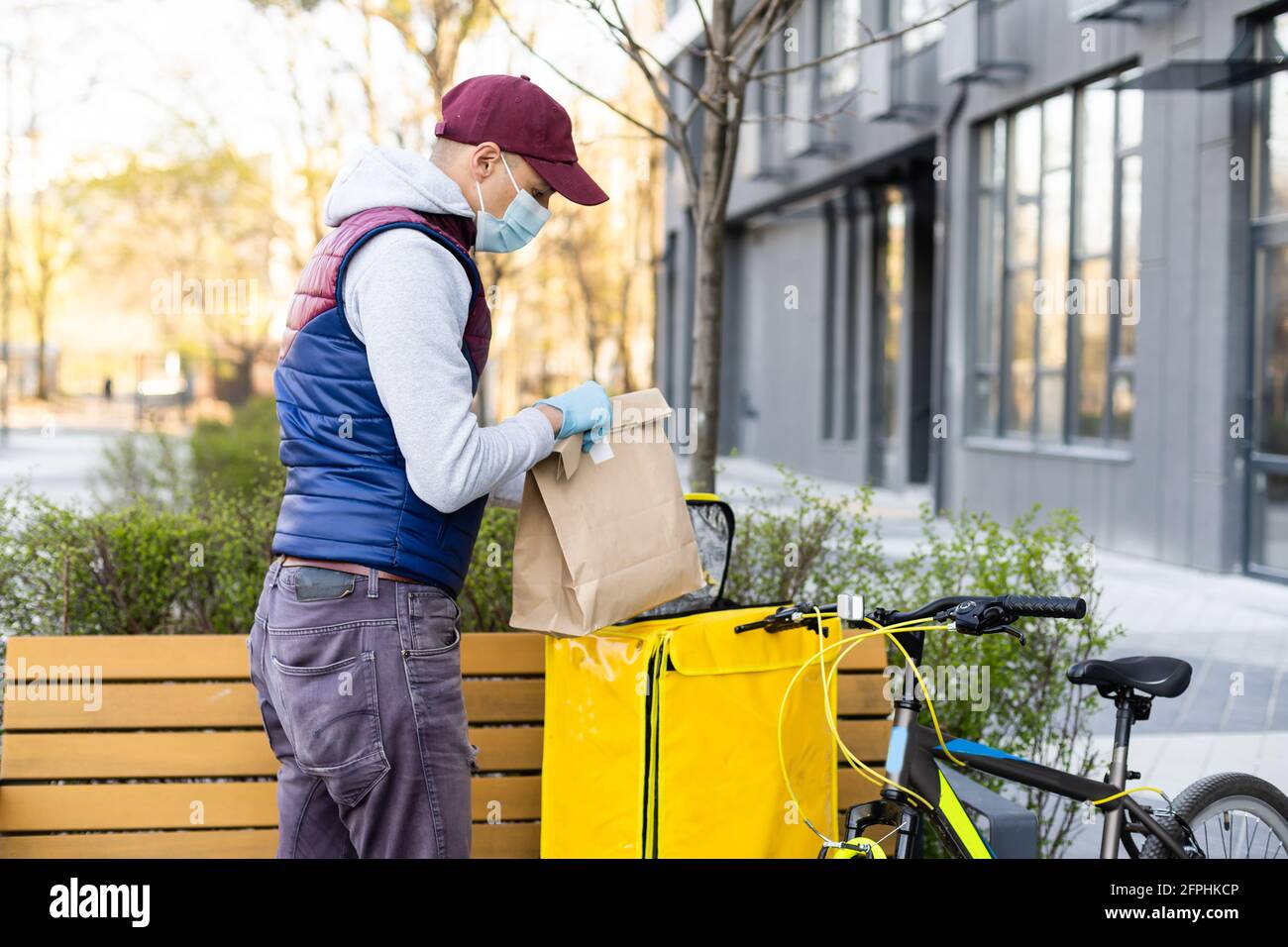Delivery man with yellow backpack hi-res stock photography and images ...