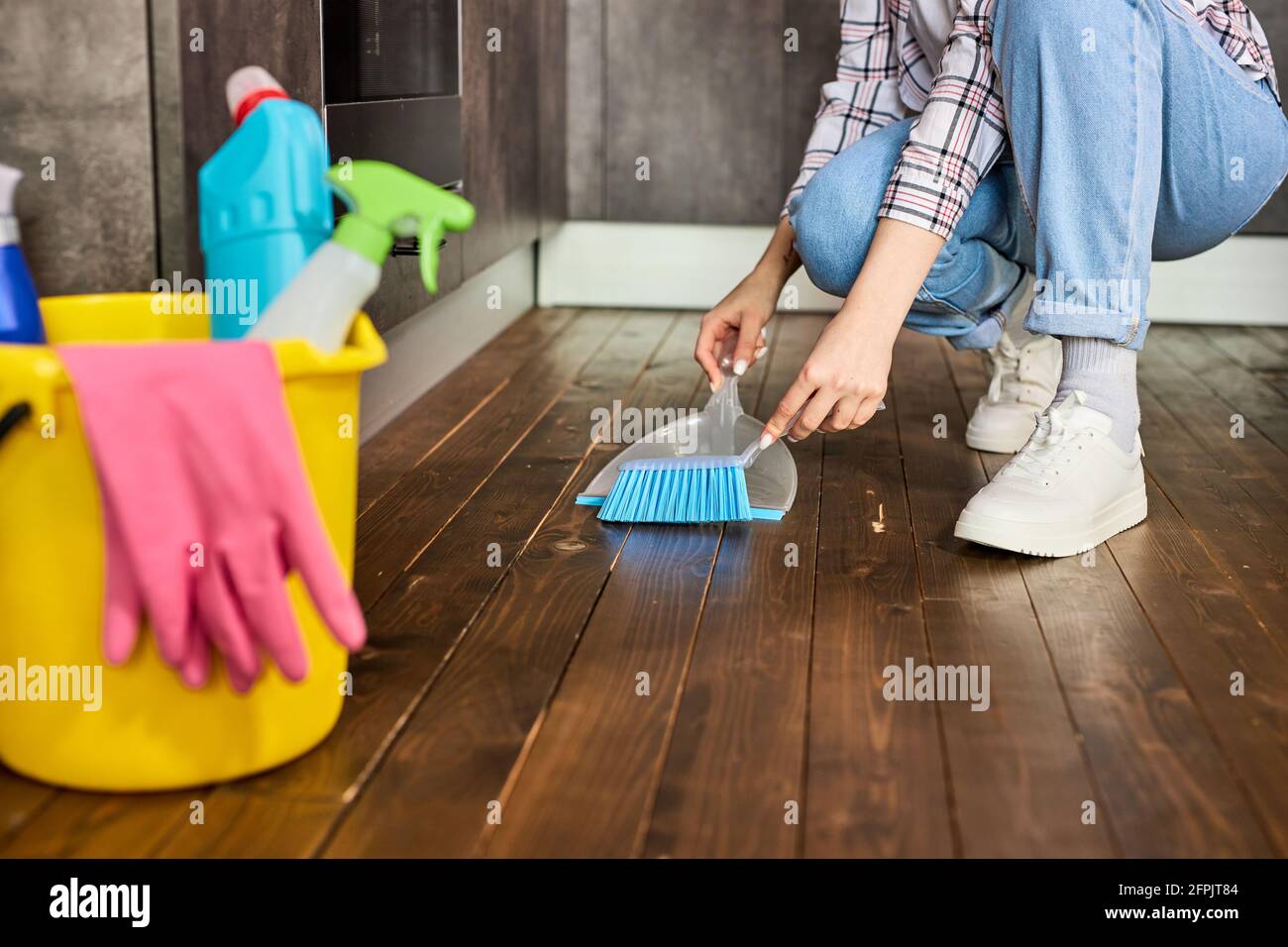 Cropped female hands sweeping Dust with brush and dustpan, holding ...