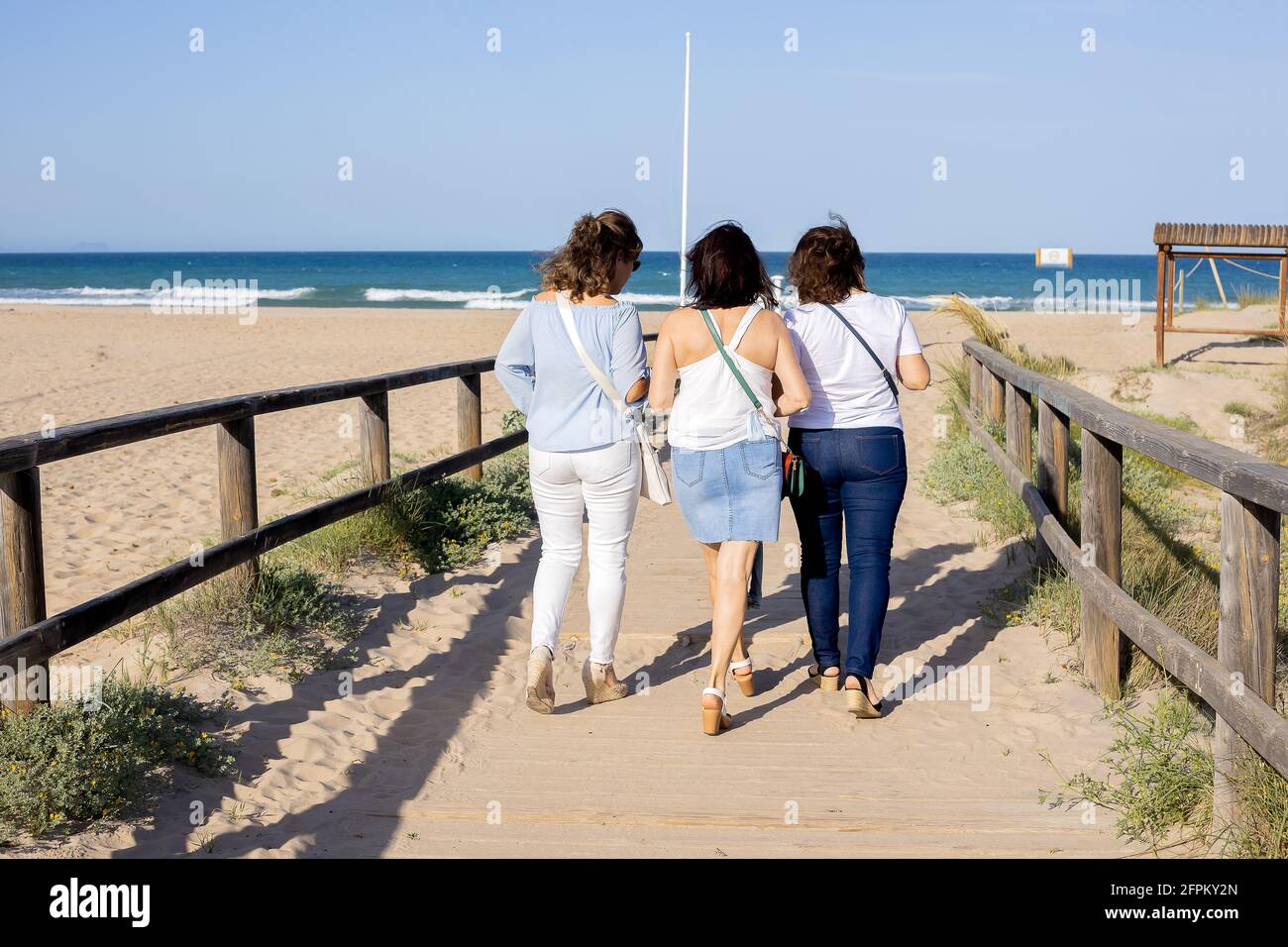 Young woman walk across suspension hi-res stock photography and images ...