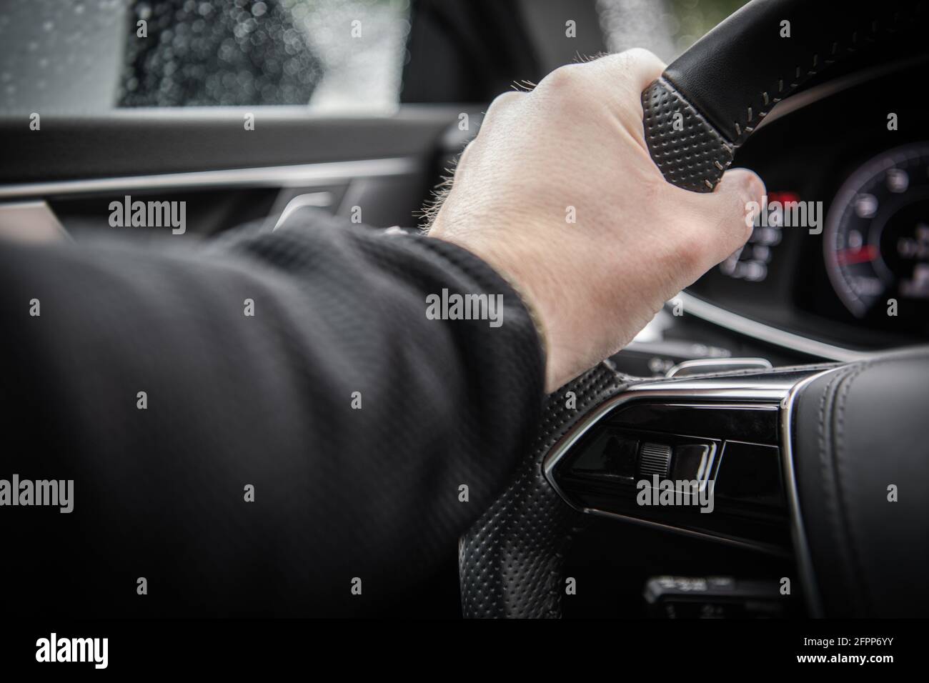 Caucasian Men Driving Modern Car. Left Hand on the Vehicle Steering ...