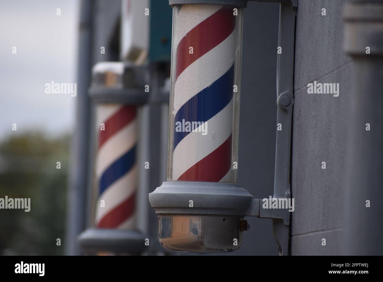 Two Barber Poles at the same Barber shop Stock Photo - Alamy